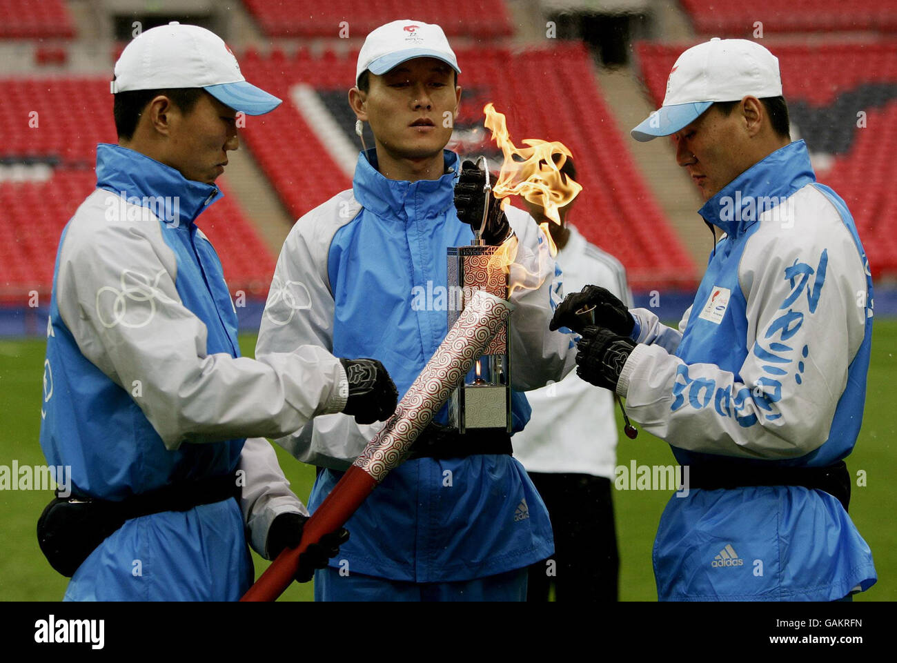 Chinese delegates light the olympic torch at wembley stadium hi-res ...
