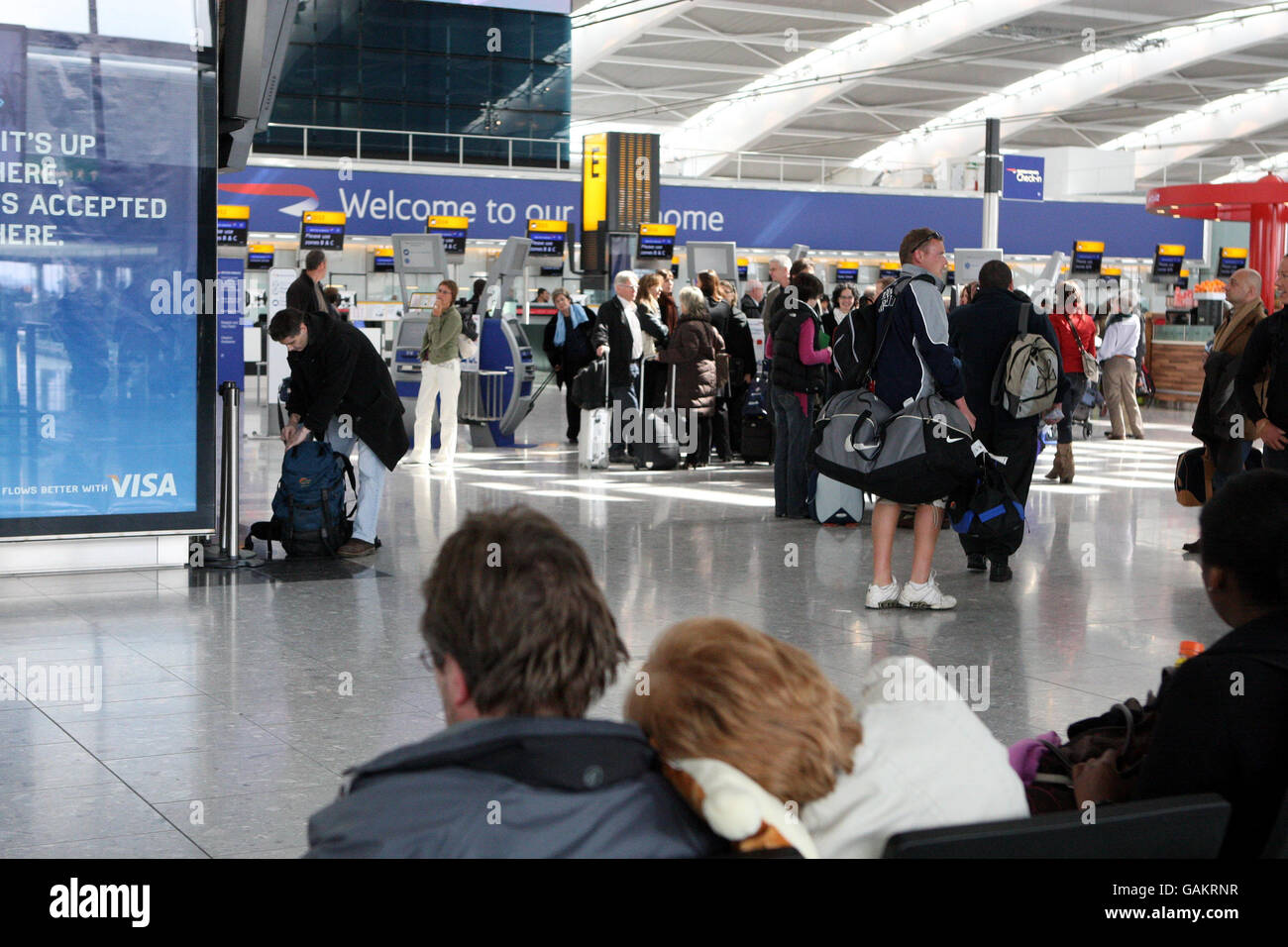 Passengers wait in Terminal 5 at Heathrow Airport after the cold ...