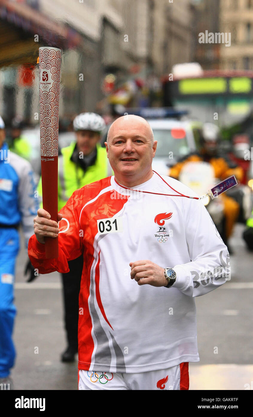 Chelsea football club CEO Peter Kenyon carries the Olympic torch during ...