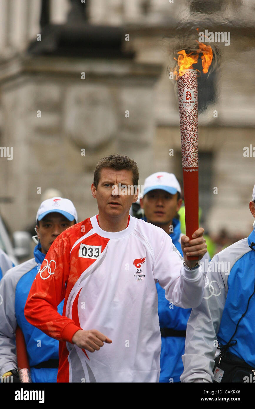 Athlete Steve Cram carries the Olympic torch during its relay journey ...