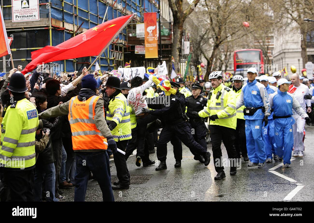 Protesters demonstrate during Clive Woodward's leg of the relay from ...