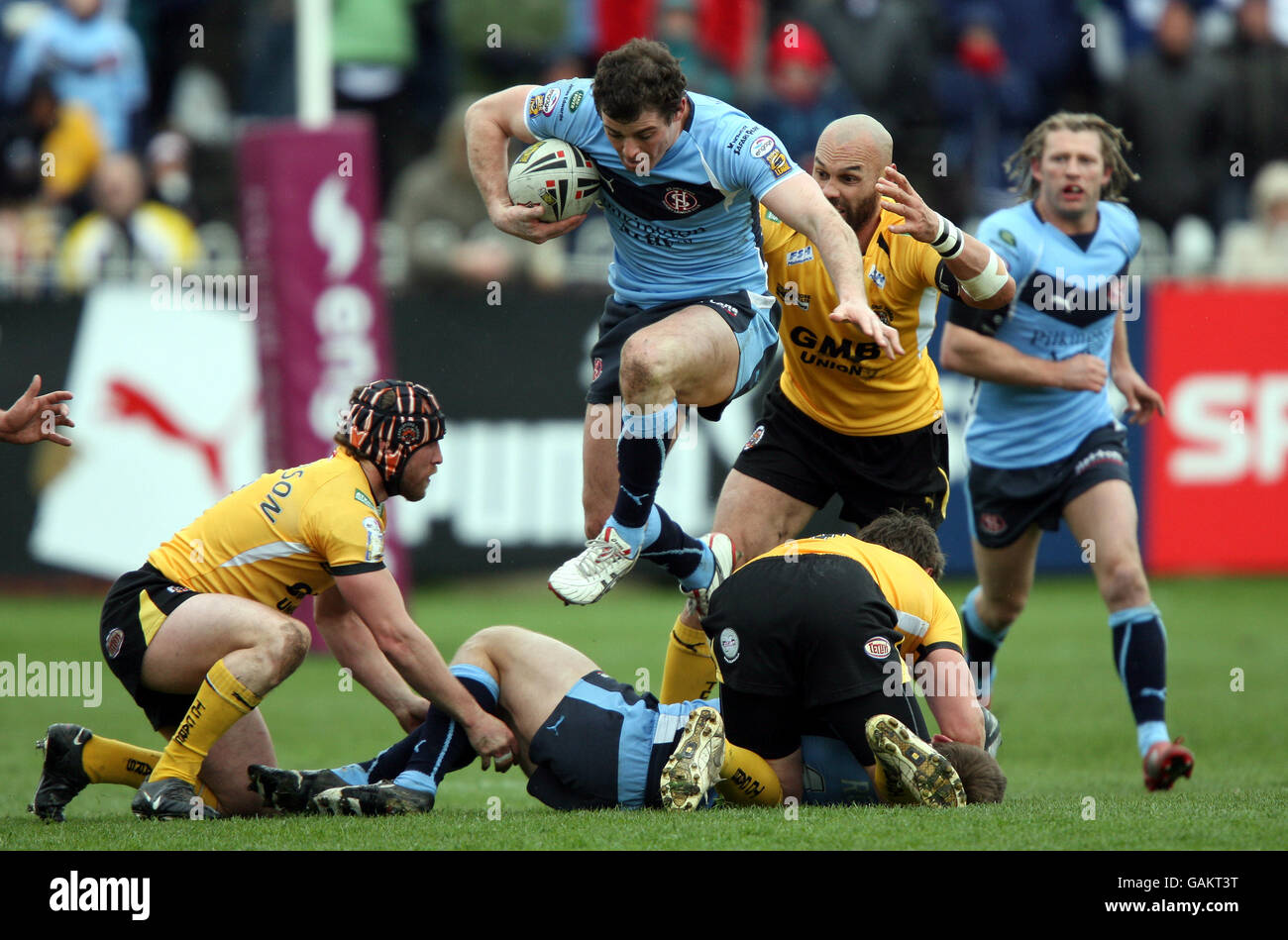 St Helens' Paul wellens jumps the tackle of Castleford Tigers' Craig ...