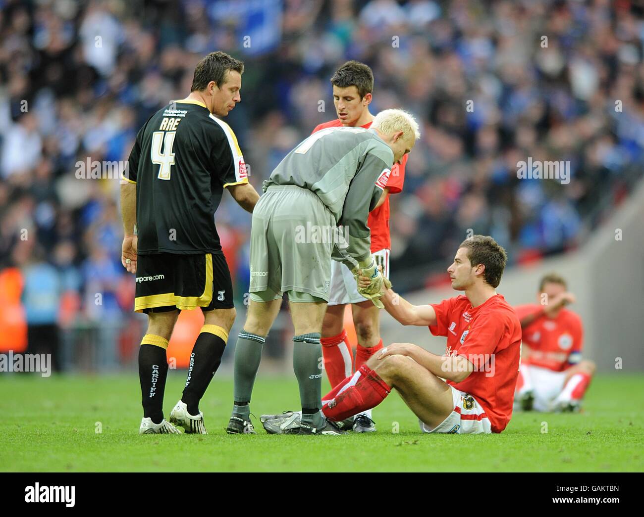 Barnsley's Stephen Foster is consoled by Cardiff City goalkeeper Peter ...