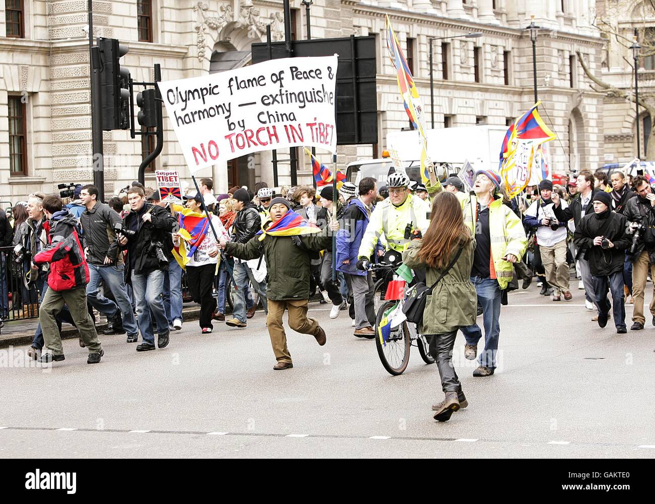 Protesters demonstrate as the torch approaches Bridge Street during the ...