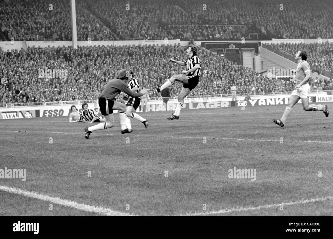 Newcastle United's Alan Kennedy (c) hacks the ball clear as goalkeeper ...
