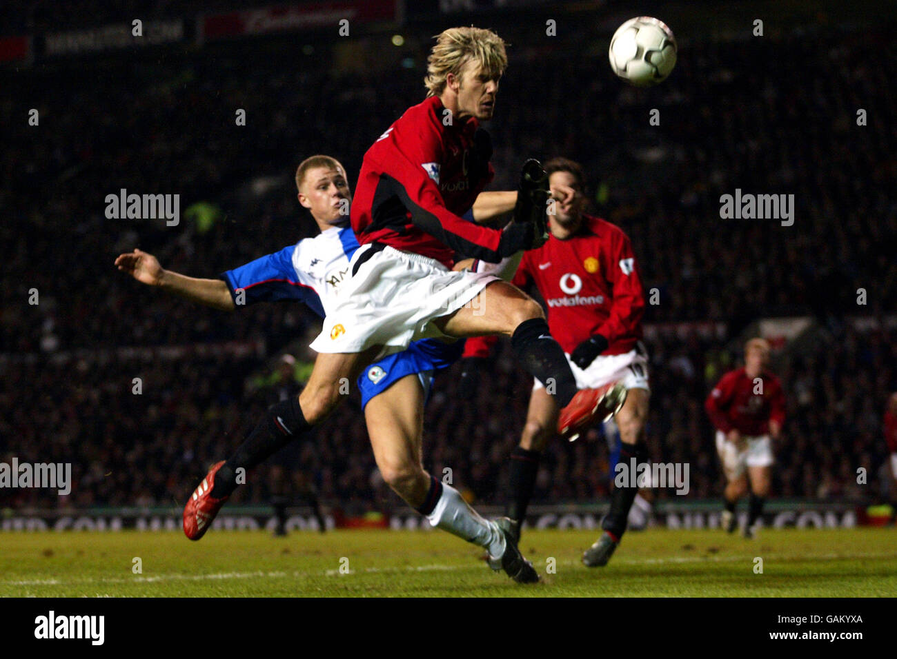 Manchester United's David Beckham shoots toward goal under presure from ...