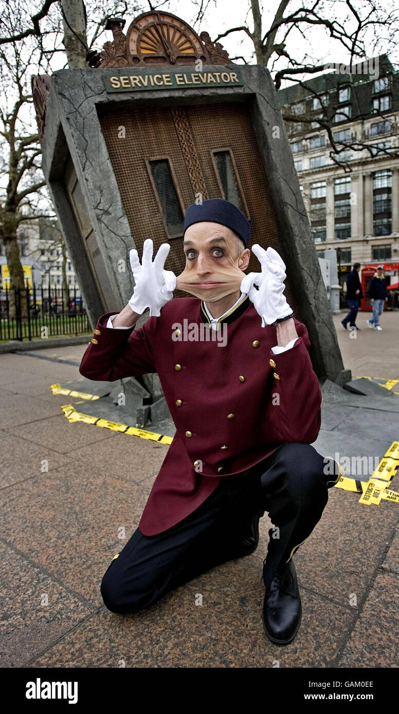 Garry Stretch poses in front of a towering lift art installation sits ...