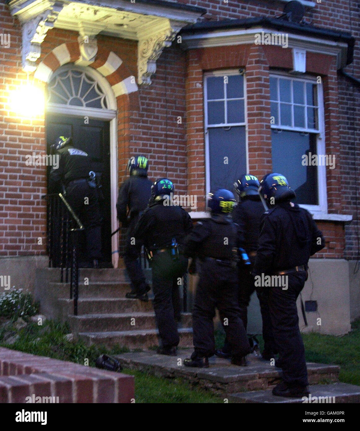 Back view police raid hi-res stock photography and images - Alamy
