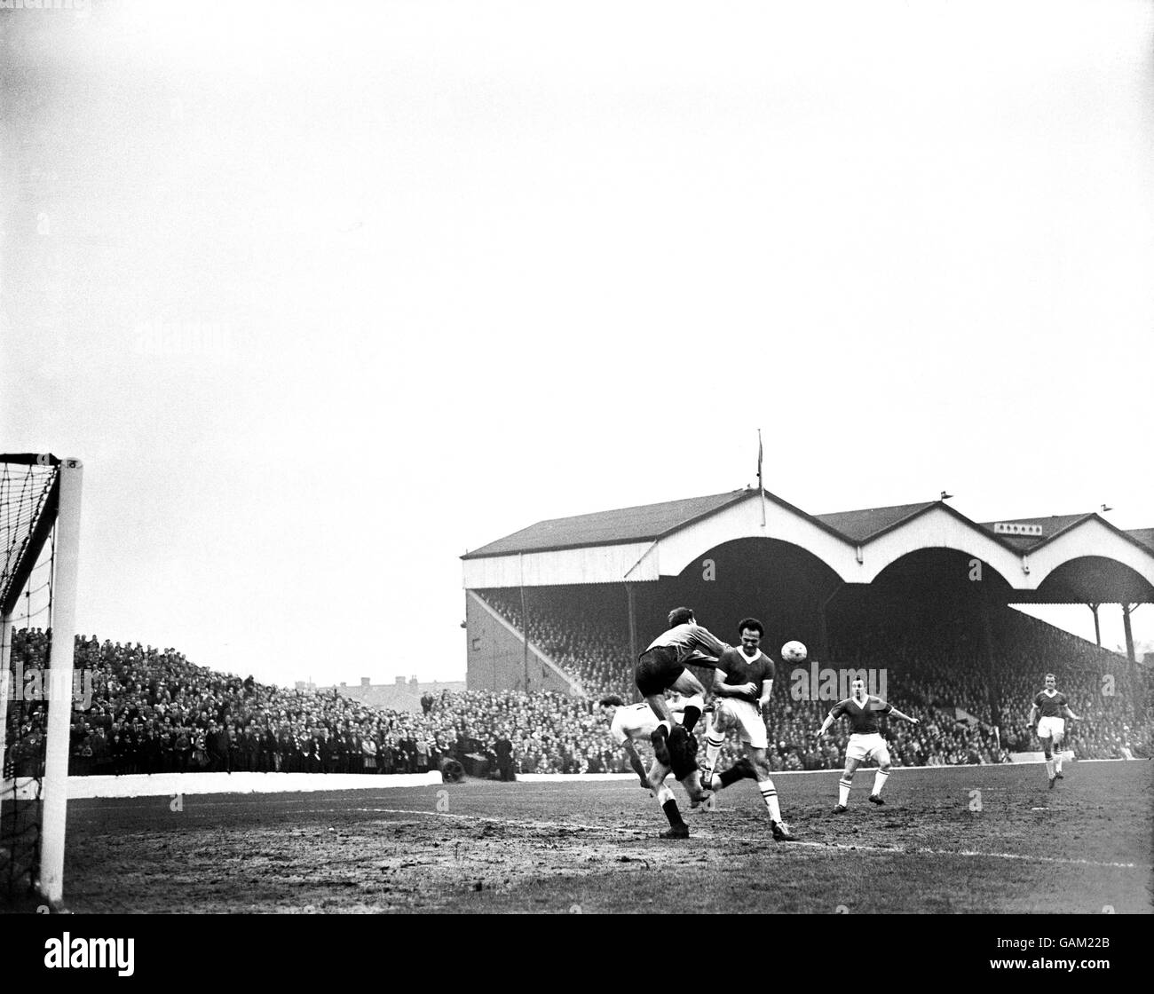 Derby County goalkeeper Reg Matthews (second l) punches clear from ...