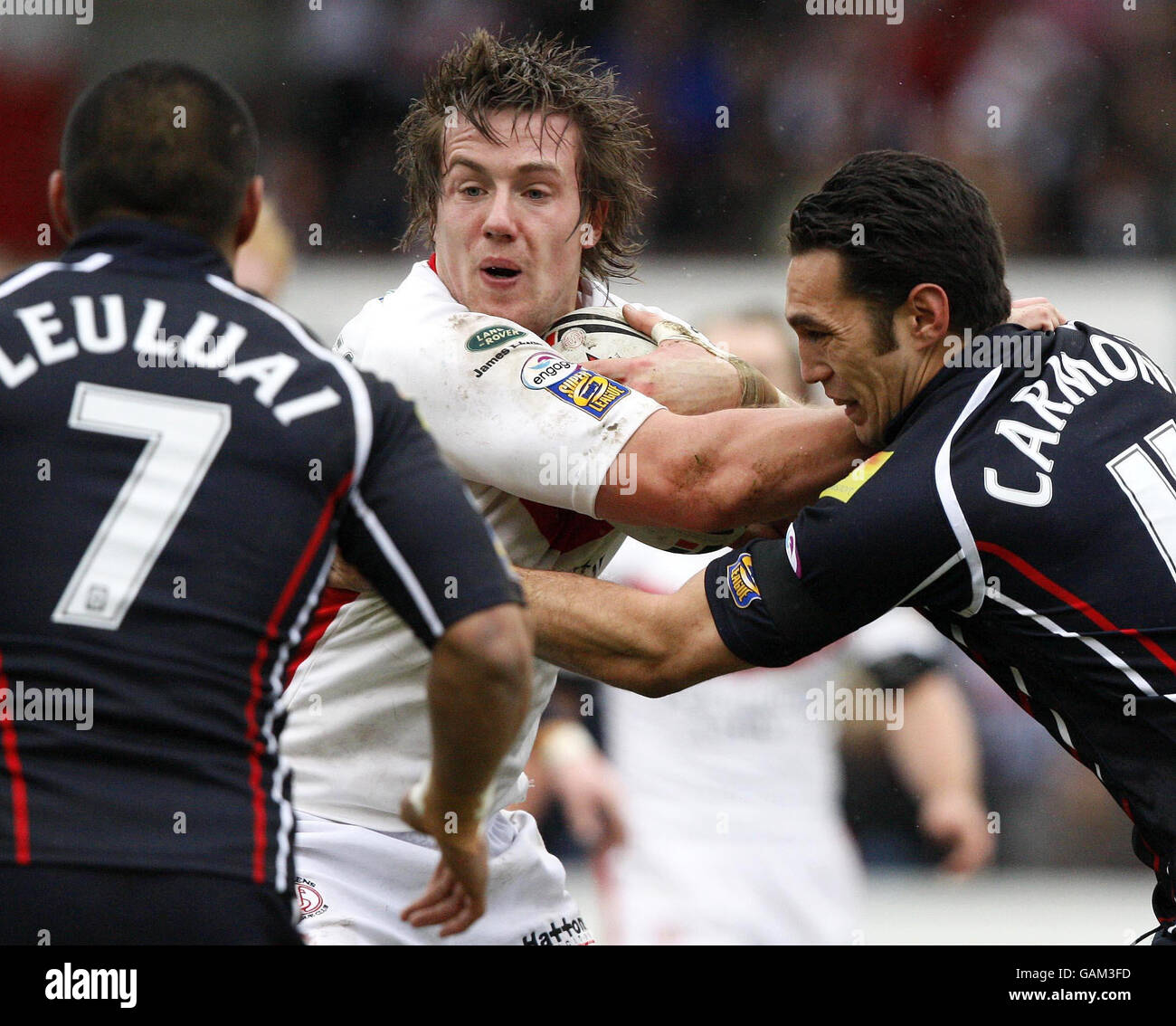 St. Helens Bryn Hargreaves (centre) is tackled by Wigan Warriors ...