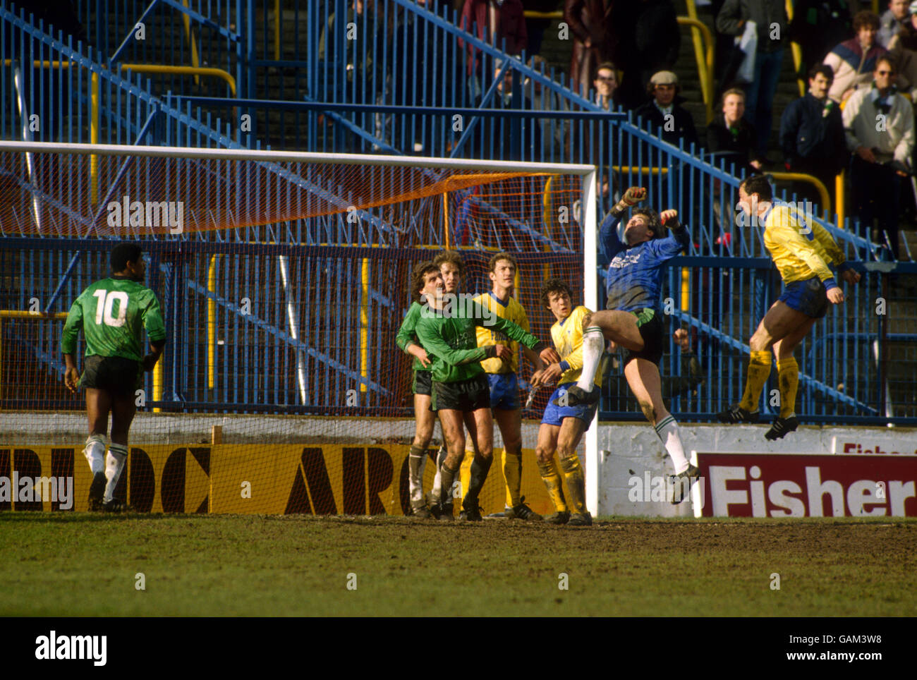 Plymouth Argyle goalkeeper Geoff Crudgington (second r) punches the ...