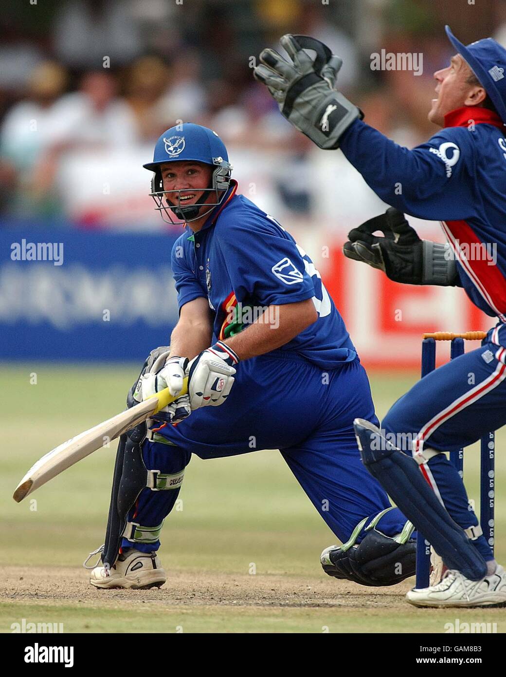 Namibia's Jan-Berry Burger sweeps the ball past England's Alec Stewart ...
