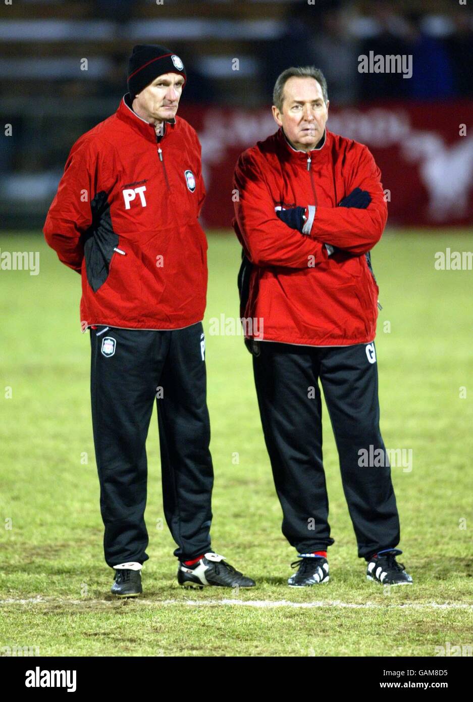 Liverpools manager gerard houllier and assistant phil thompson watch ...