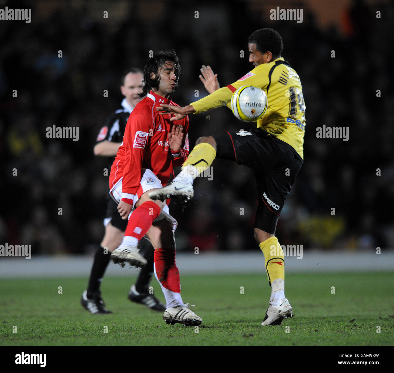 Watford's Lee Williamson and Barnsley's Diego Leon in action Stock ...