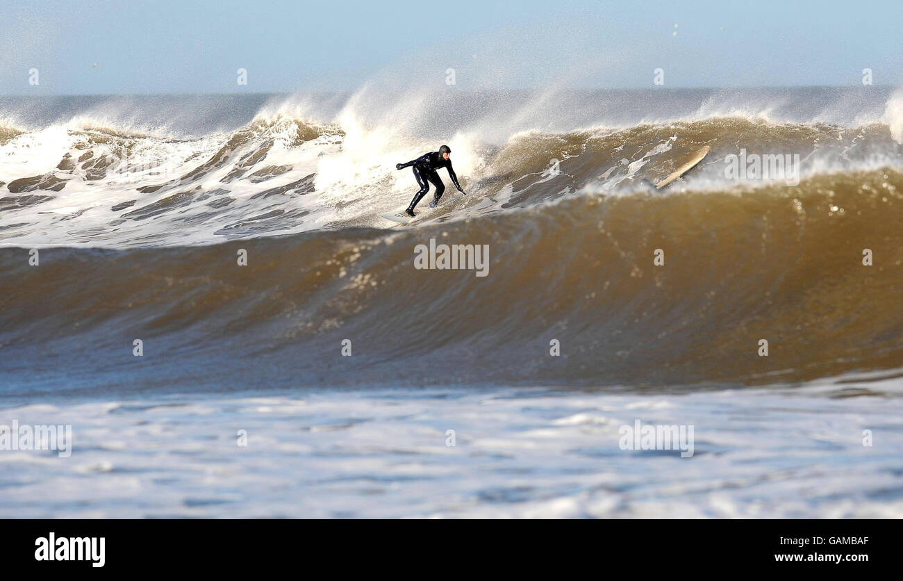 Strong storm predicted. Surfers enjoy the huge surf at Tynemouth as ...