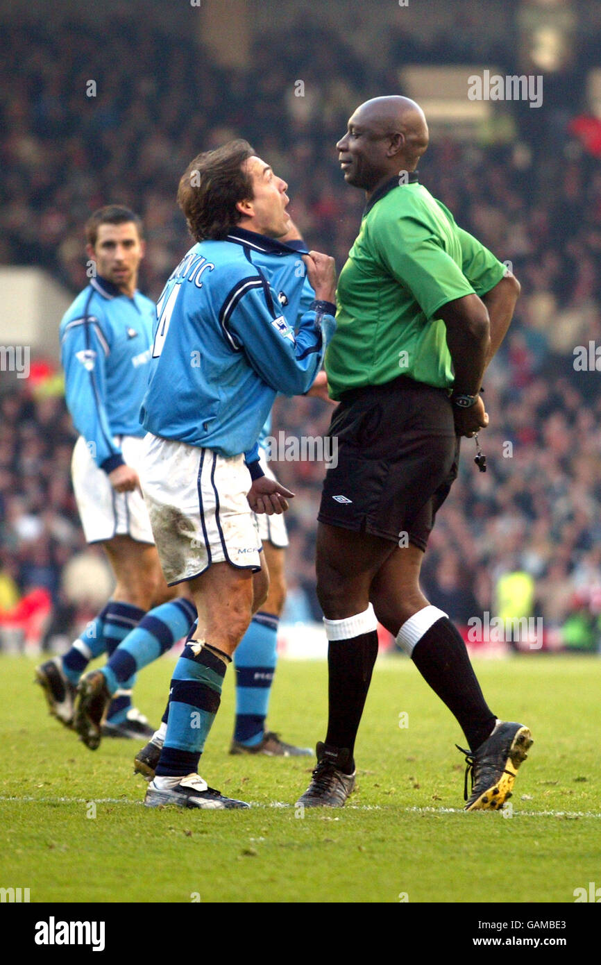 Manchester City's Eyal Berkovic argues with referee Uriah Rennie as he ...