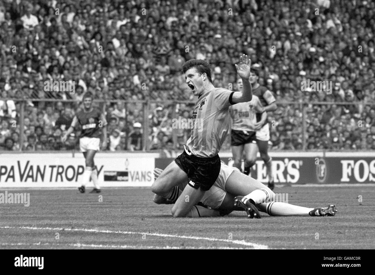 Wolverhampton Wanderers' goalscorer Andy Mutch (left) is brought down ...