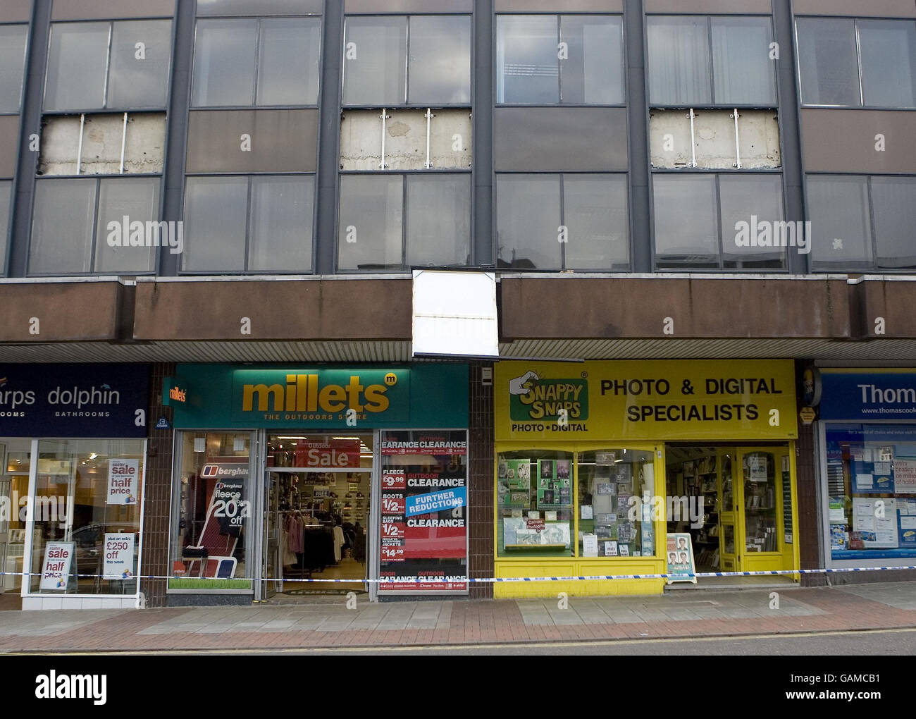 A damaged shop facade is seen on the High Street in Harrow following ...