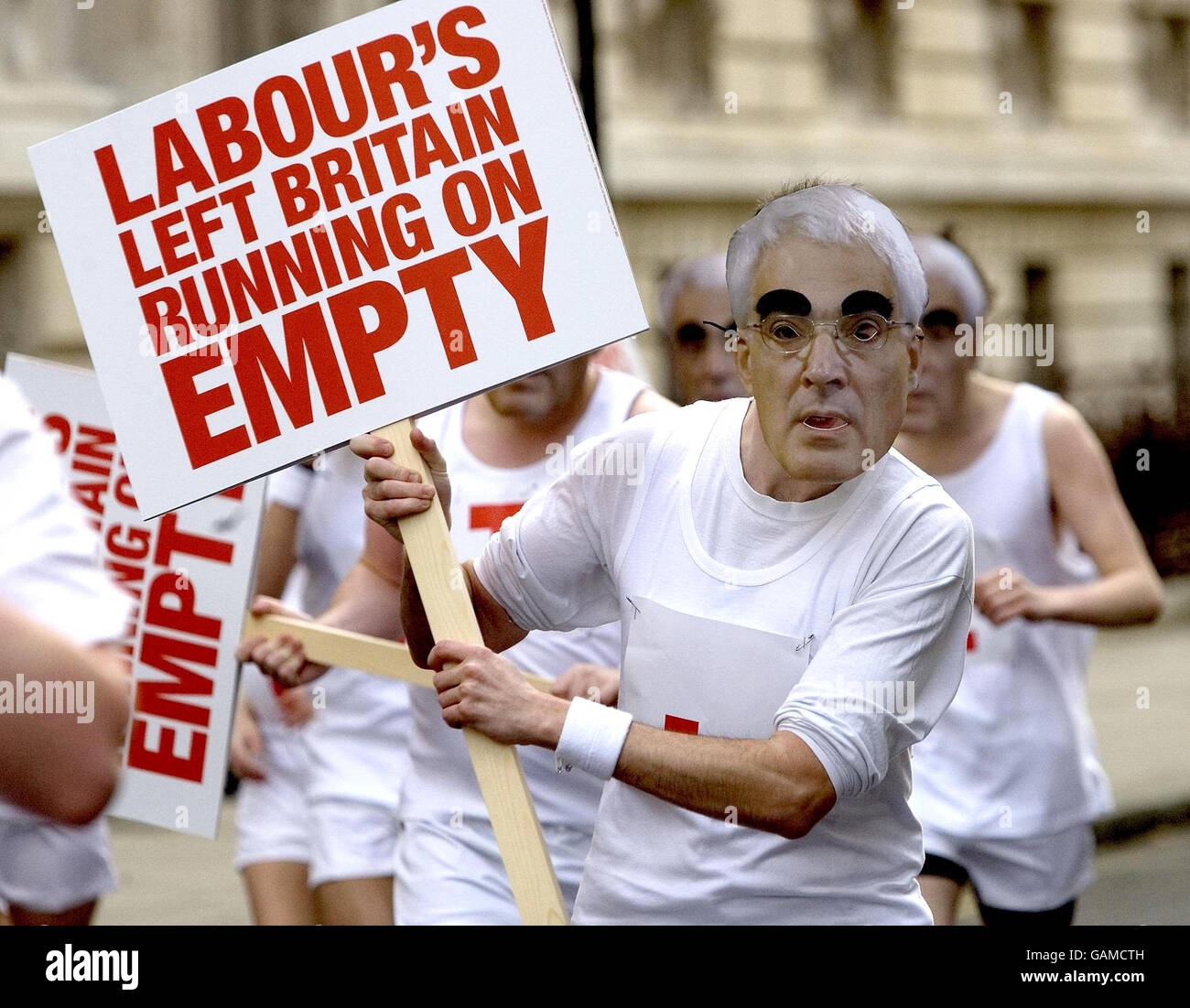 Conservative party supporters wear Alistair Darling facemasks as they ...