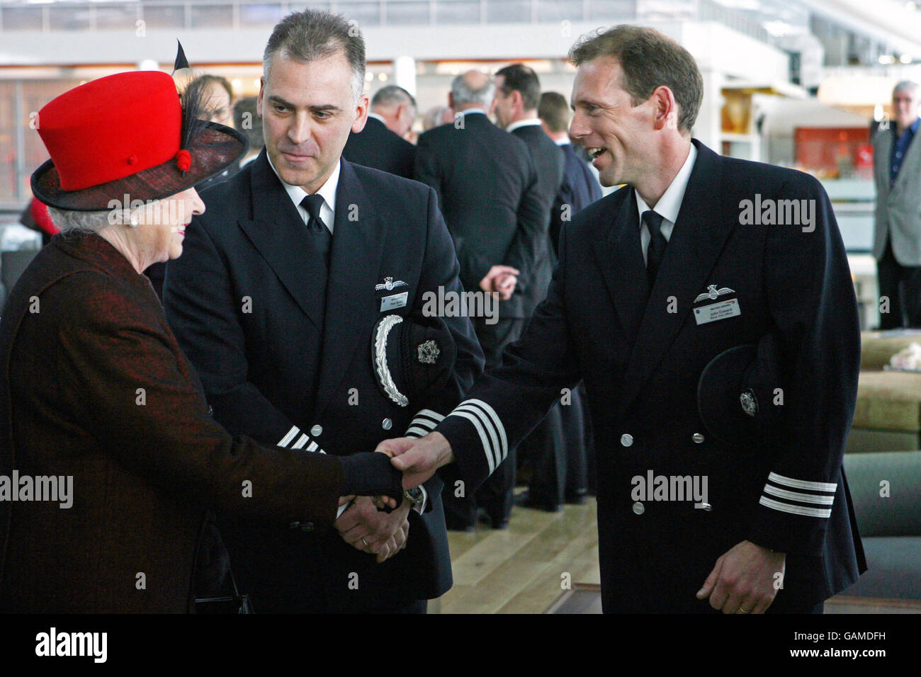 Britain's Queen Elizabeth II meets captain Peter Burkhill (centre) and ...