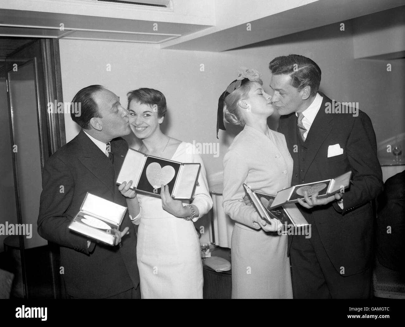 Elizabeth Seal, second left, and Mary Ure get a kiss from Tommy Trinder ...