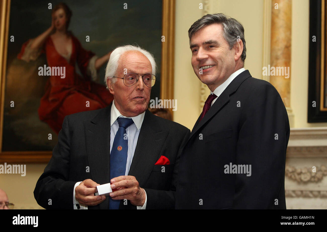 Prime Minister Gordon Brown gives Lord Brian Rix a commemorative badge ...