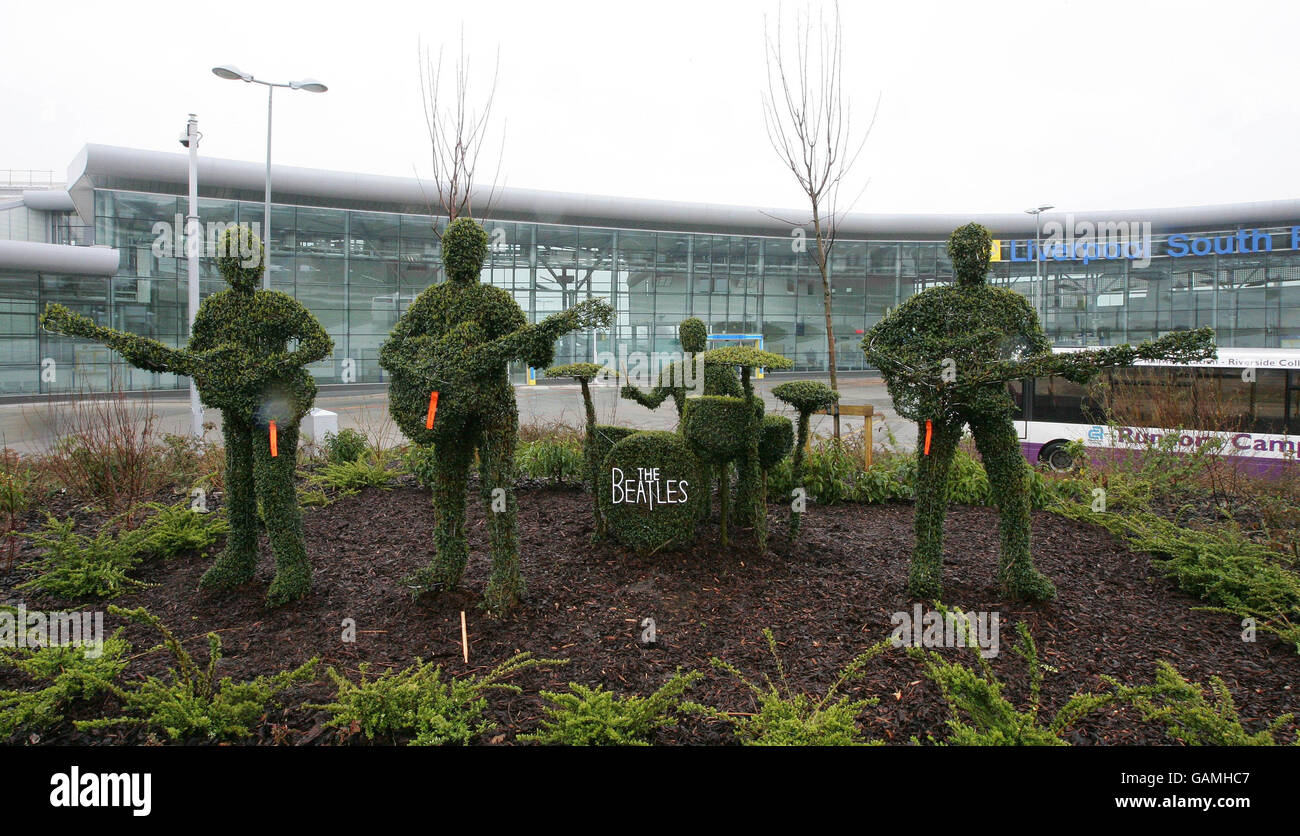 Topiary figures in the shape of the Beatles outside Liverpool South ...