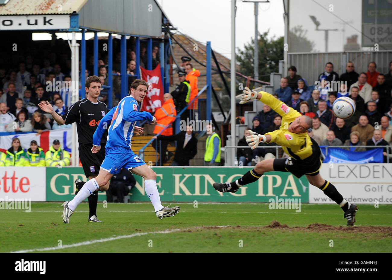 Colchester United's Scott Vernon (blue stripes) scores the opener past ...
