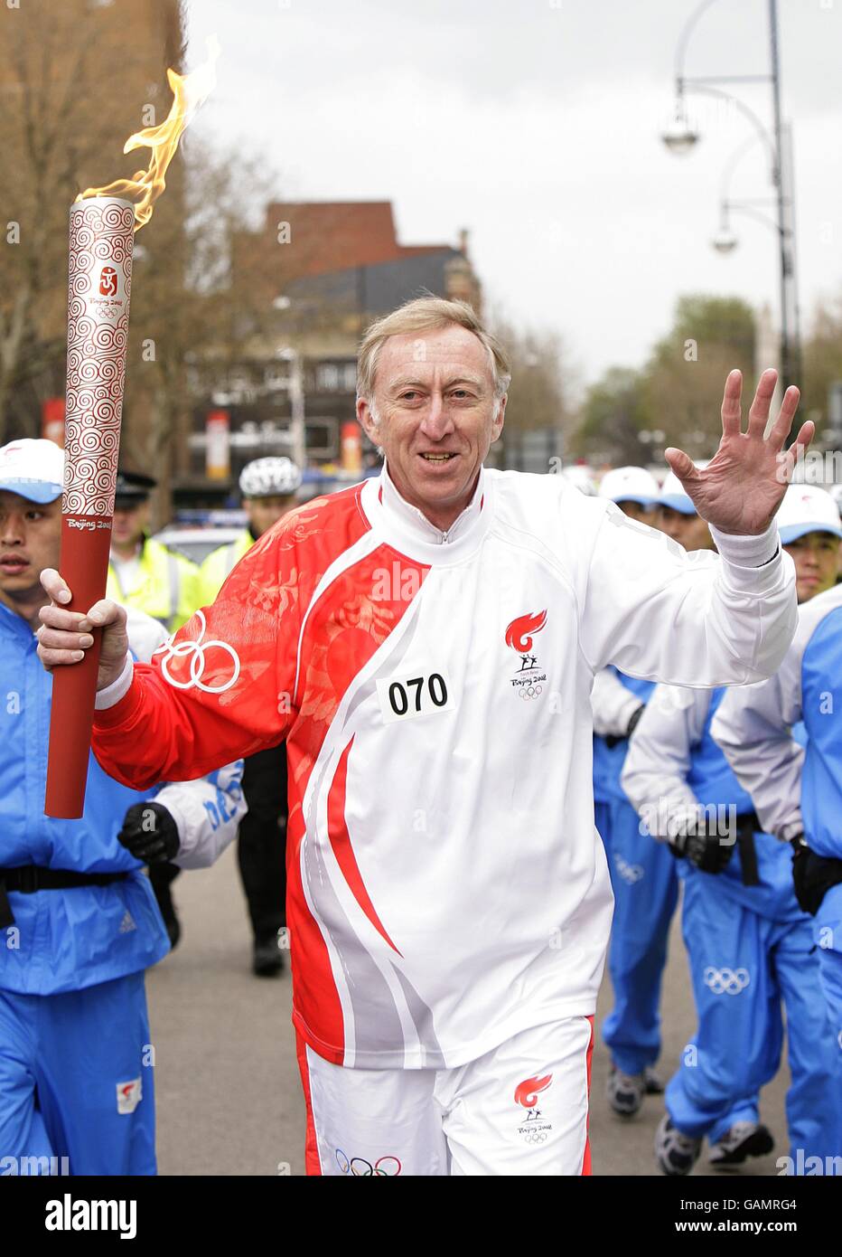 David Hemery carries the torch from Stratford during the Beijing ...