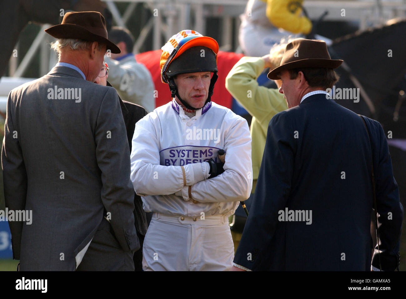 jockey Mick Fitzgerald waits to mount his ride in the paddock Stock ...