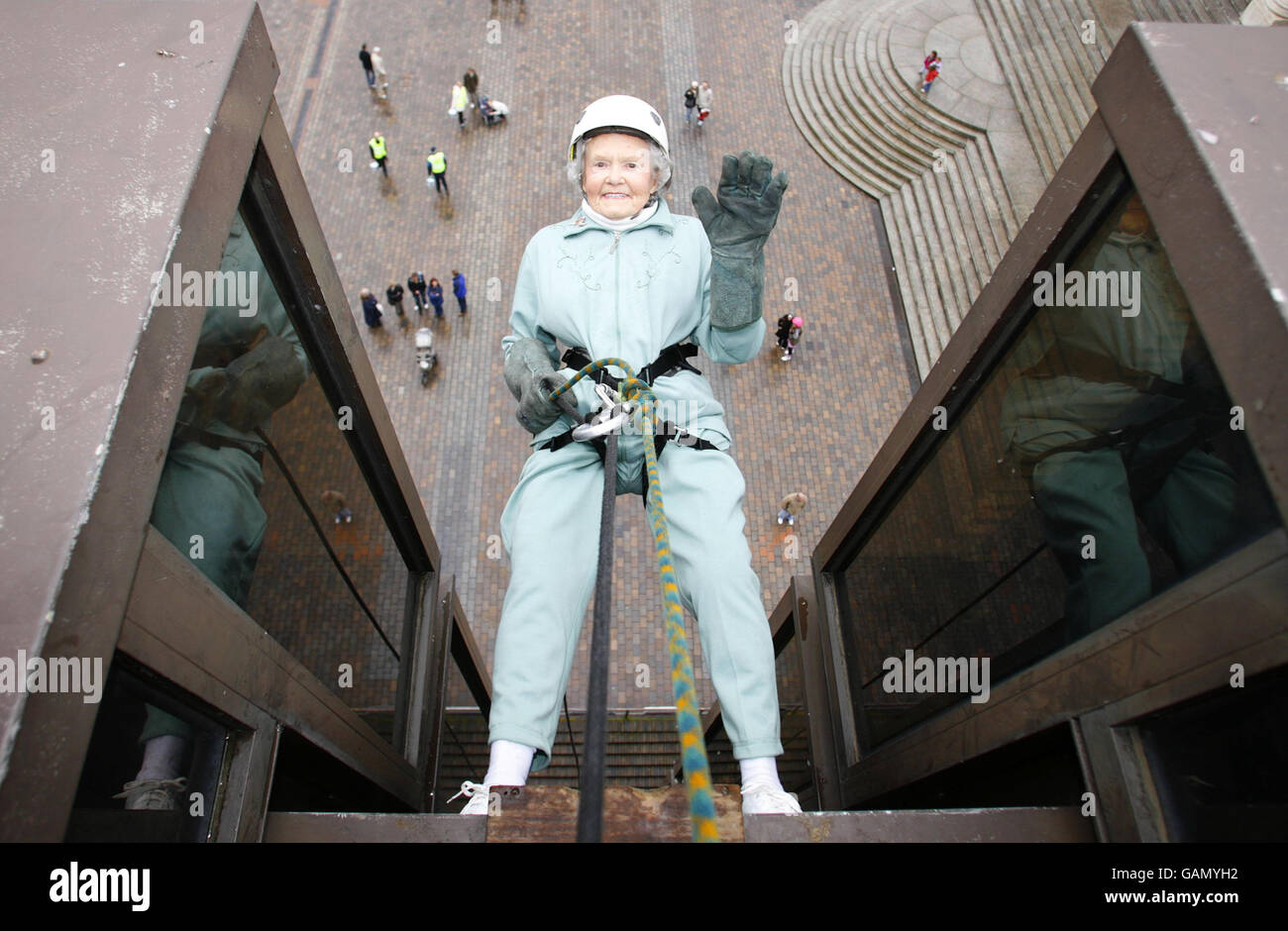 Pensioner abseils down building Stock Photo - Alamy