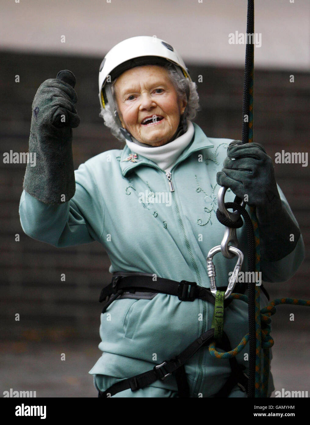 Pensioner abseils down building Stock Photo - Alamy