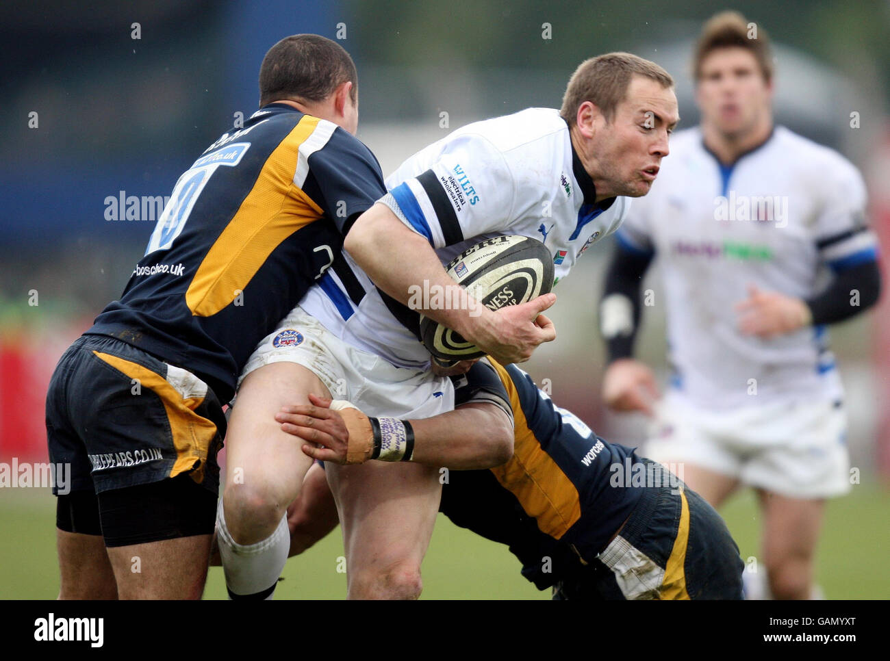 Bath's Butch James is tackled by Worcester's Shane Drahm and Thinus ...