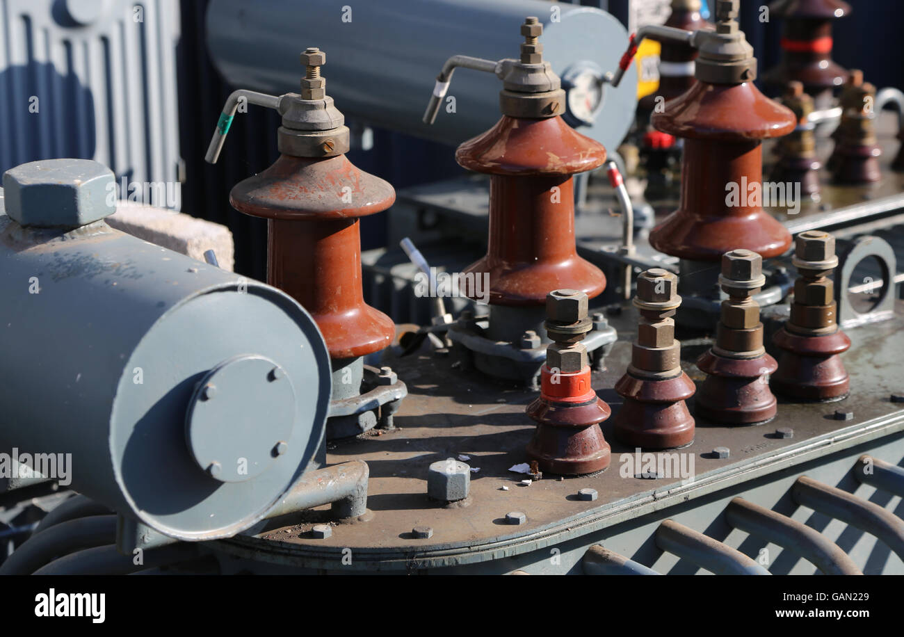 many old large electric voltage transformers in the dump of the eco ...