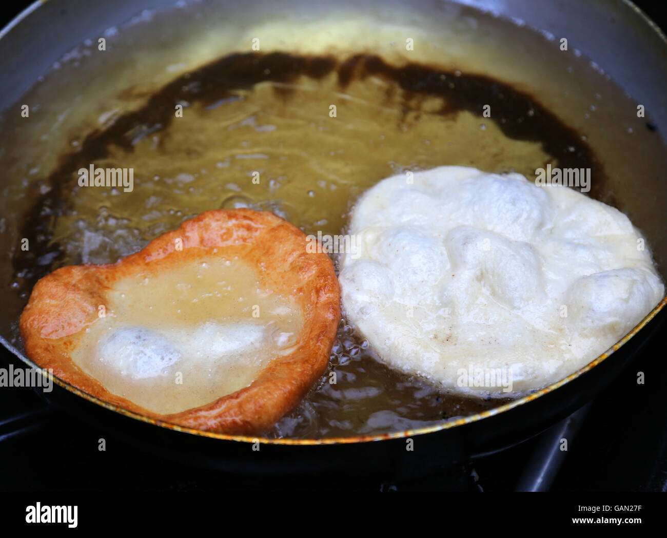 two italian traditional sweet pastry fried in hot oil Stock Photo - Alamy