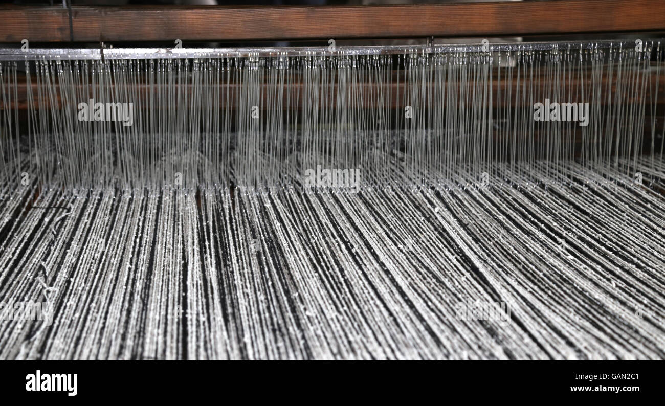 ancient textile loom of wood with black and white color woolen threads ...