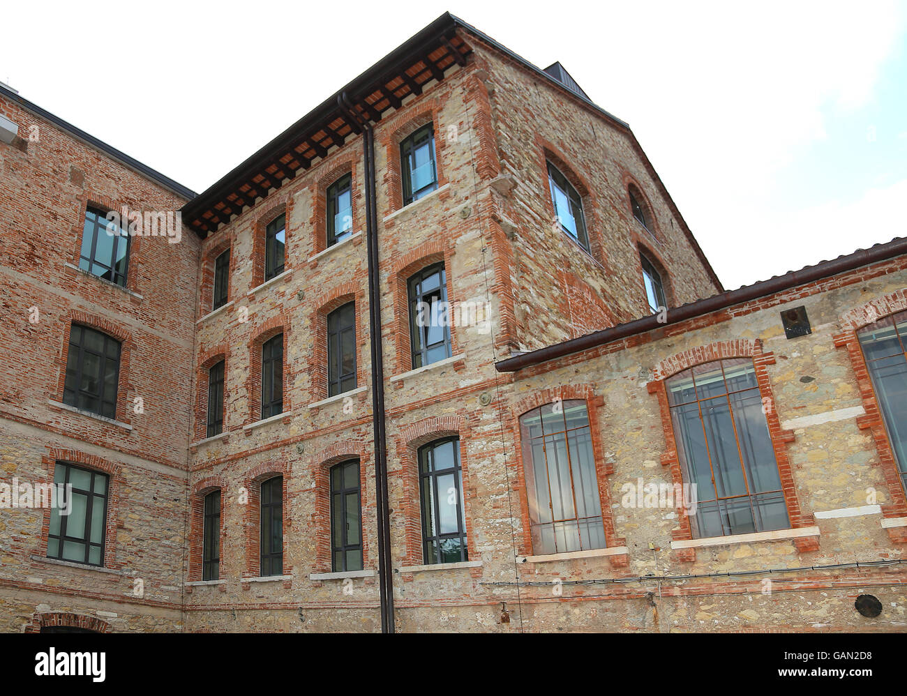 architectural detail of the windows of an old industrial building with ...