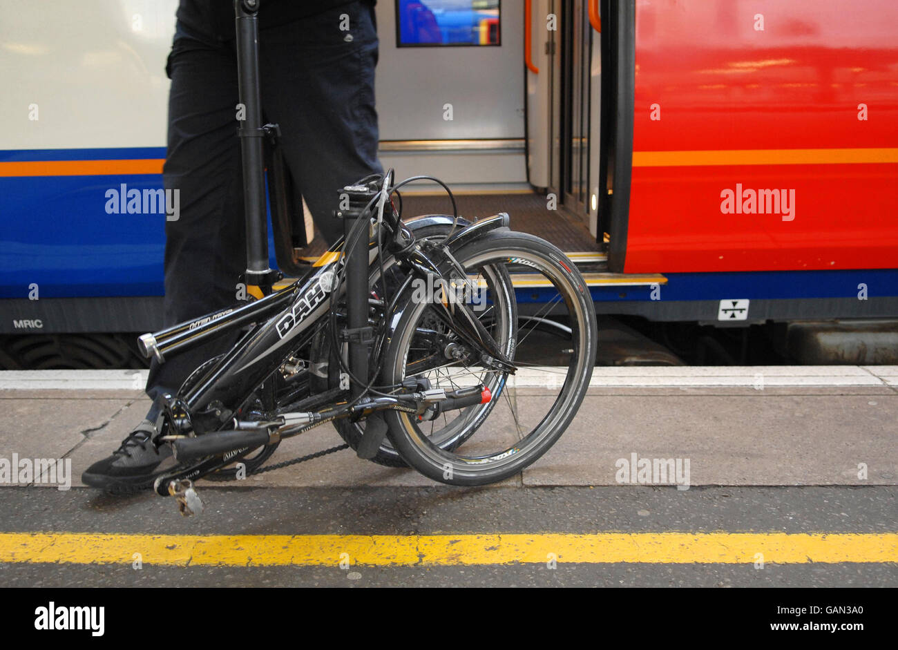 Man walks off train at london waterloo with folding bike hi-res stock ...
