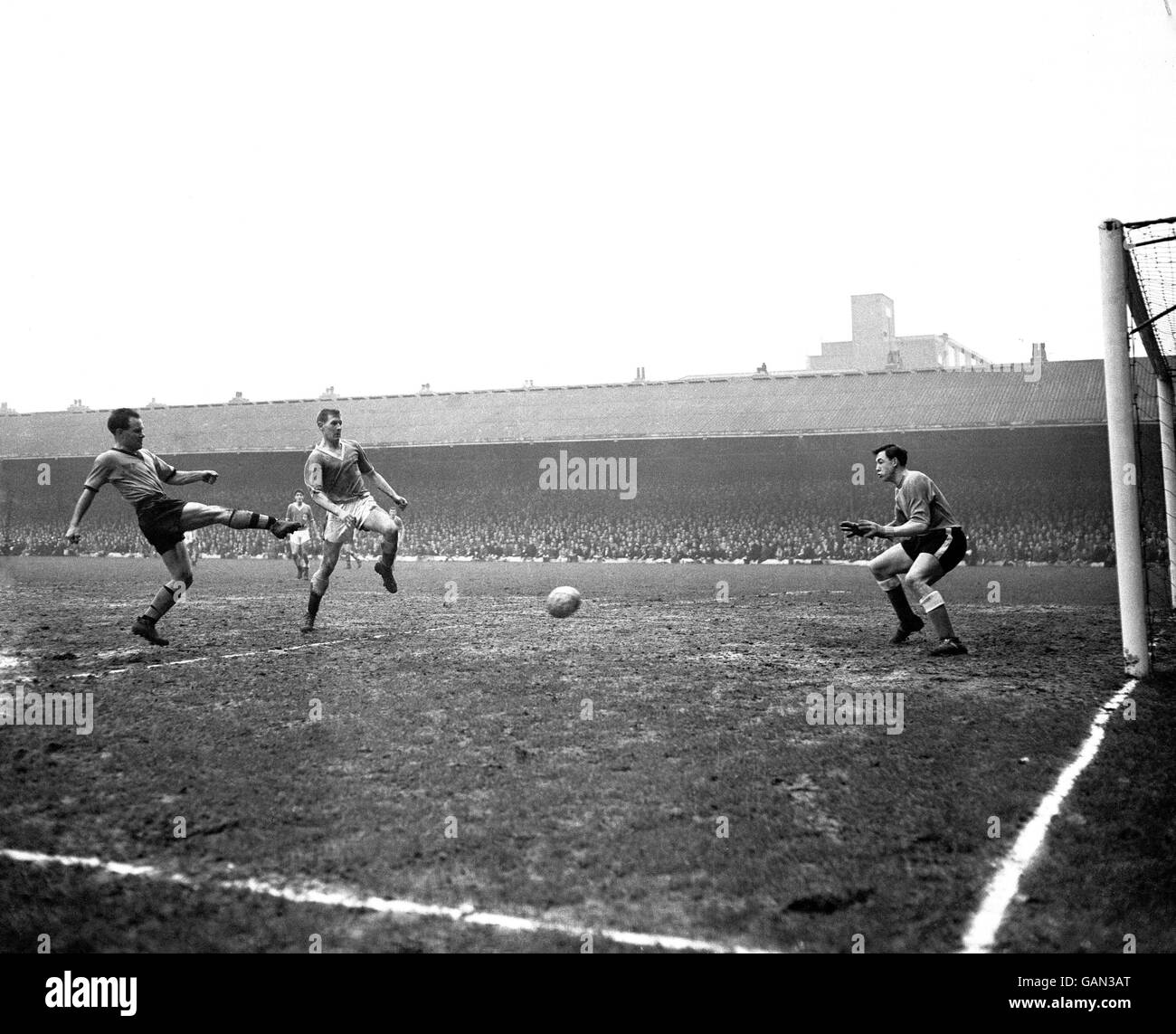 (L-R) Wolverhampton Wanderers' Norman Deeley fires in a shot at goal ...