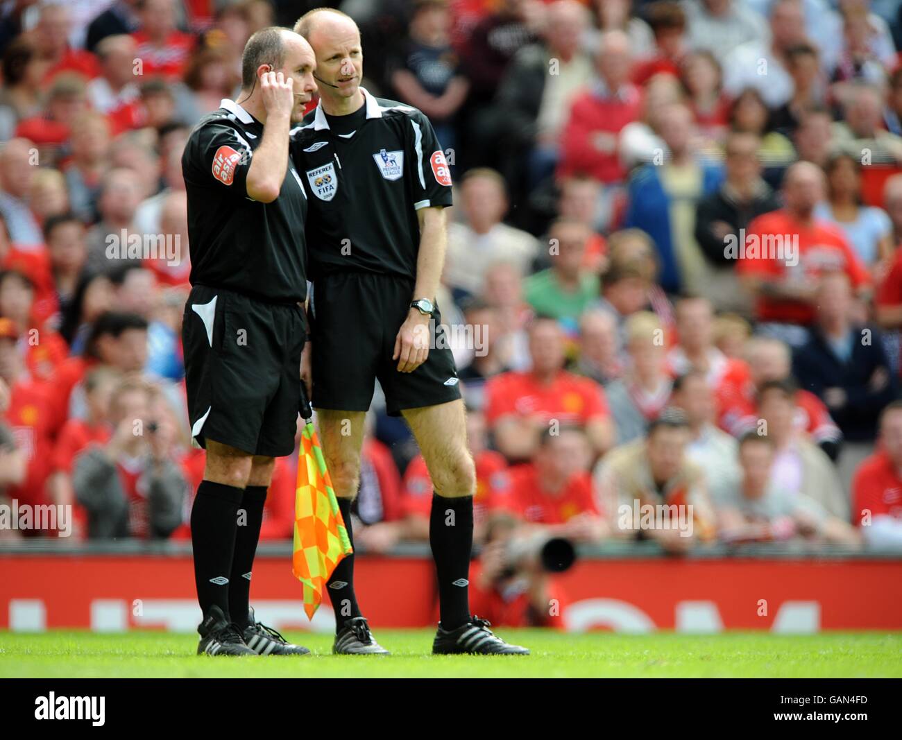 Referee Mike Riley in discussion with his assistant referee over the ...