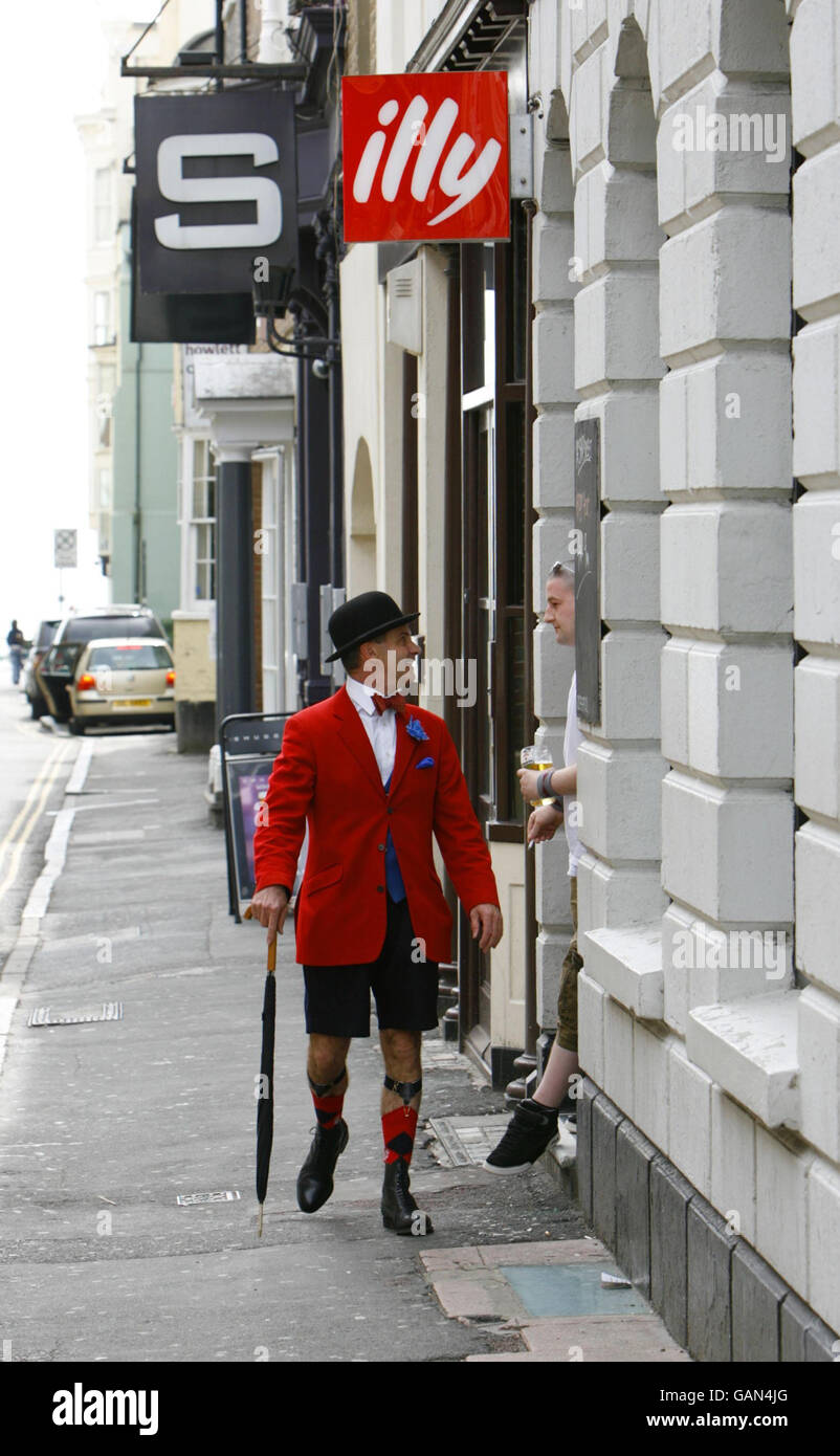 Entertainer Tim Bat practices his act beneath two shop signs in Ship ...