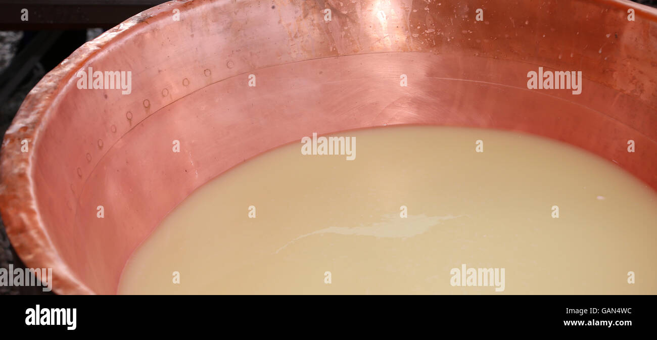 large copper pot with the milk and the whey for the production of ...