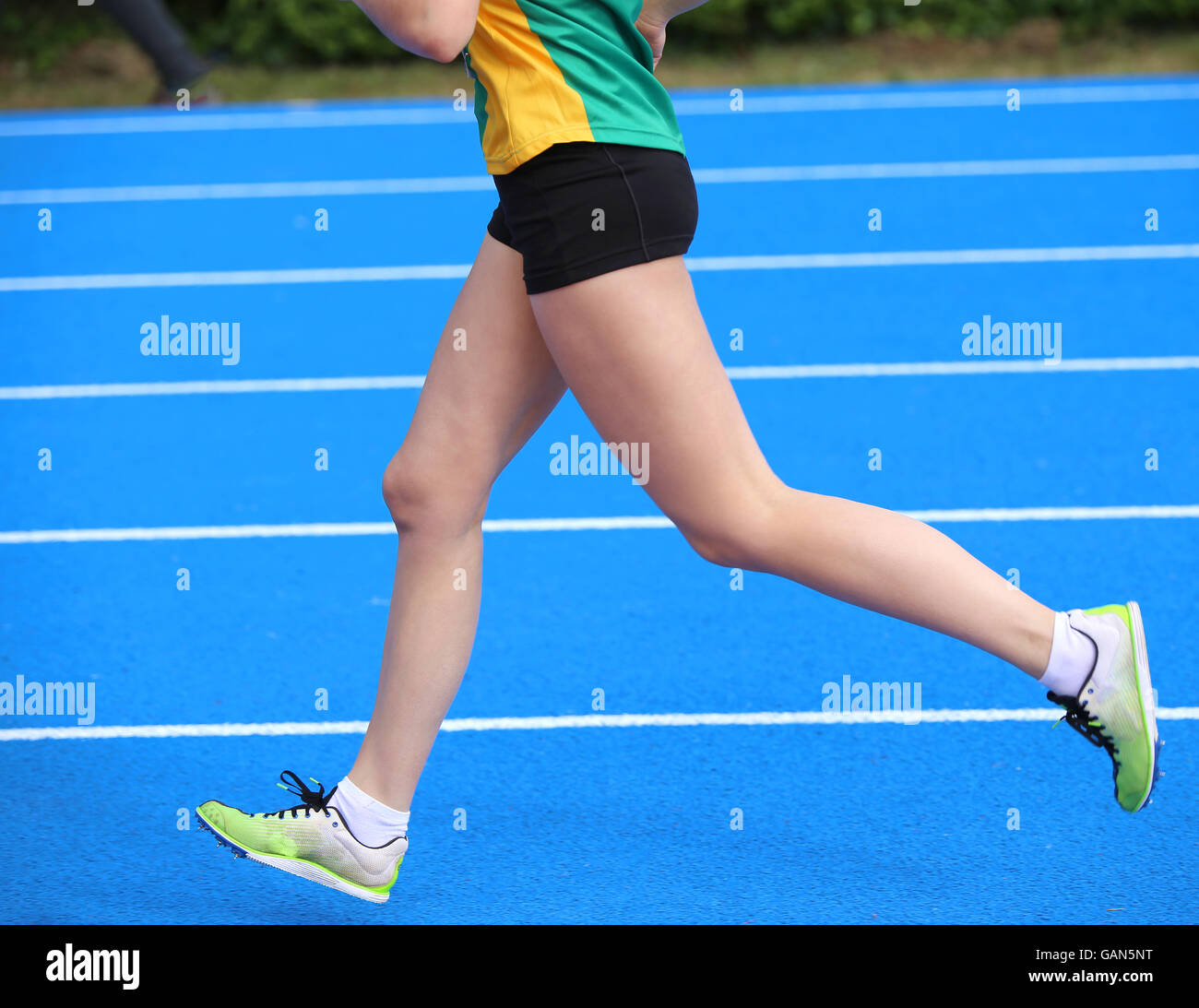 long legs of young female athlete runs in athletics track Stock Photo ...