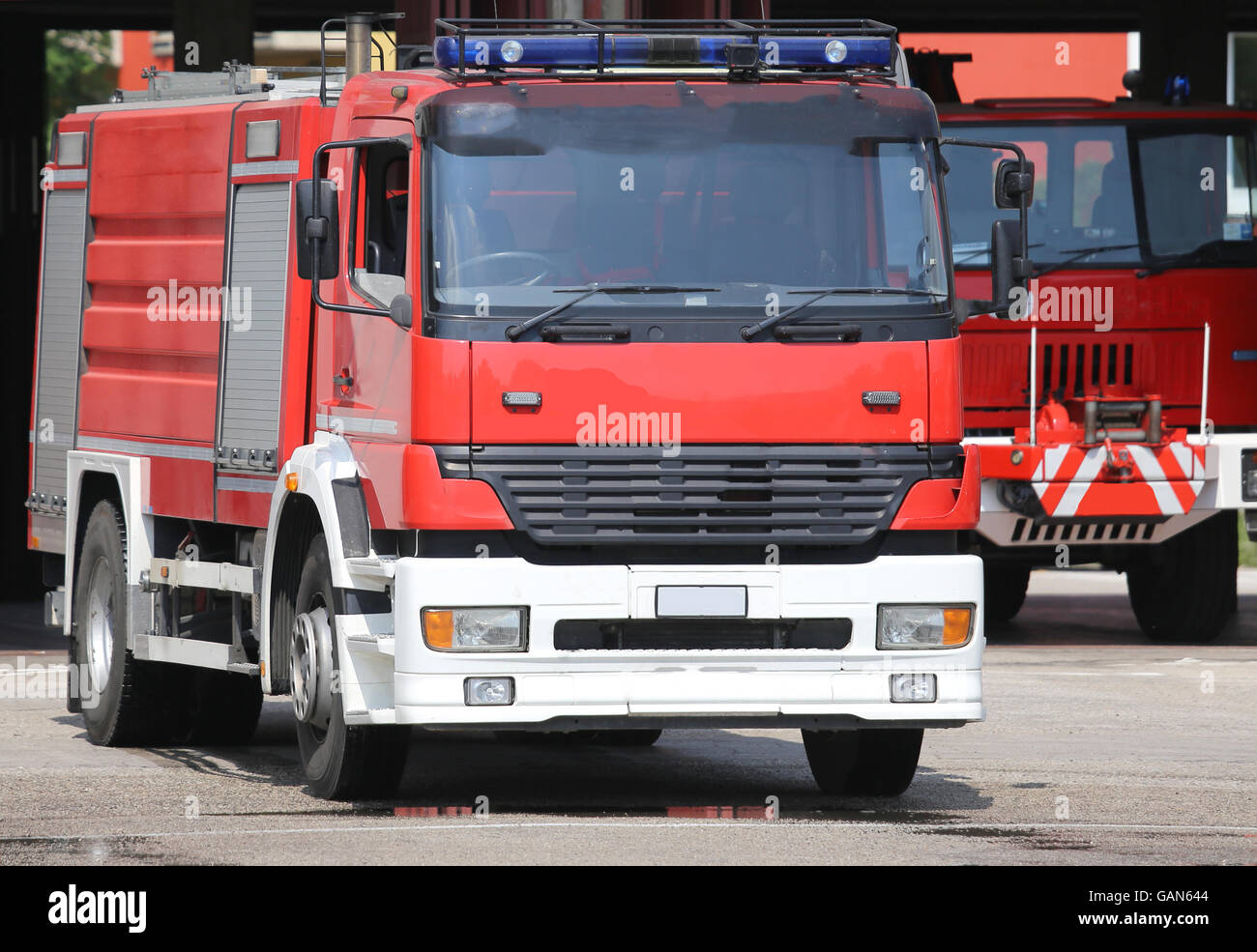 two red truck fire engines firefighters during a fire drill training in ...