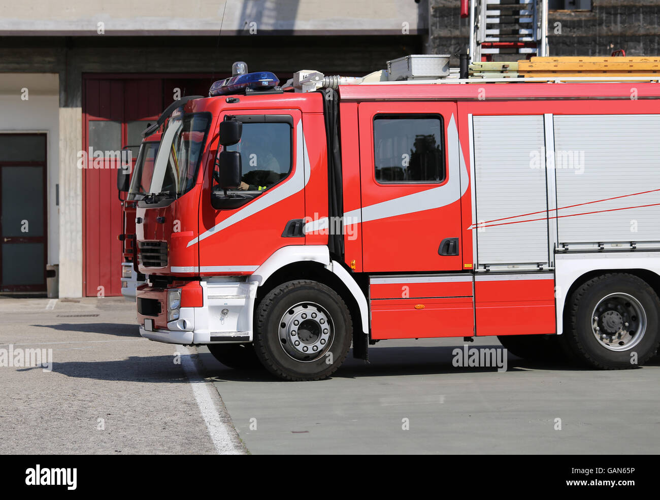 big fire engine truck during a fire drill in the fire brigade station ...