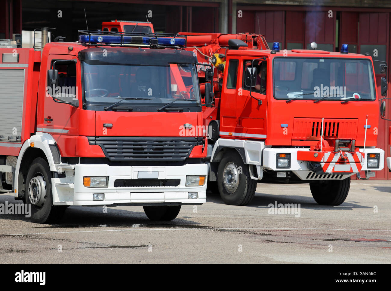 two truck fire engines firefighters during a fire drill training in the ...