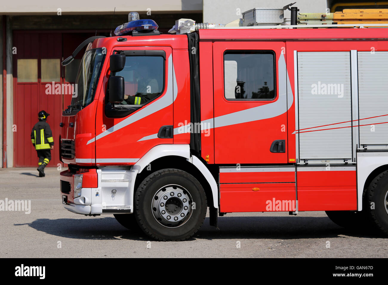 red fire engine truck during a fire drill in the fire brigade station ...