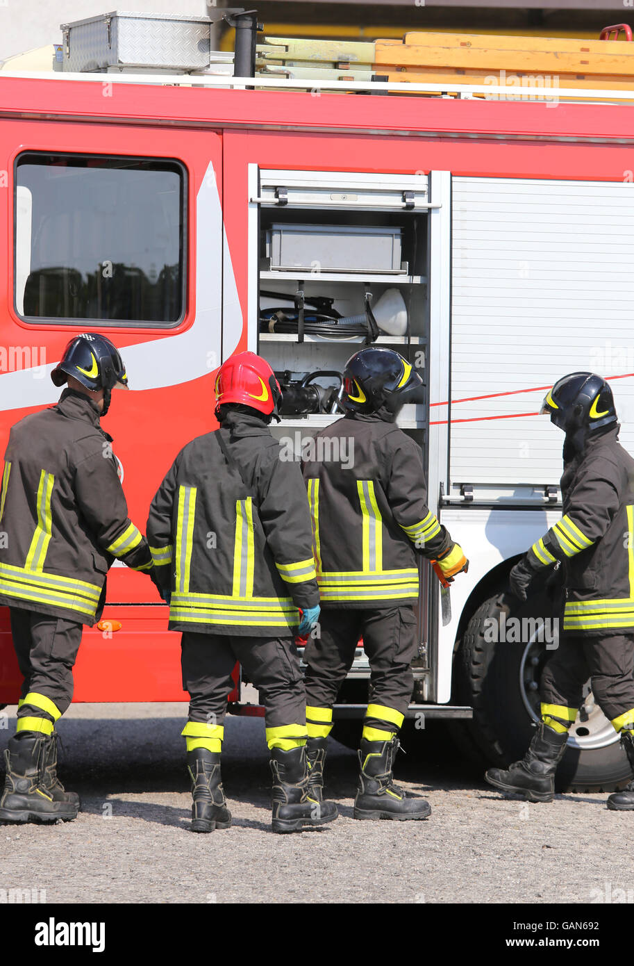 brave firefighters with fire engine truck during an exercise in fire ...