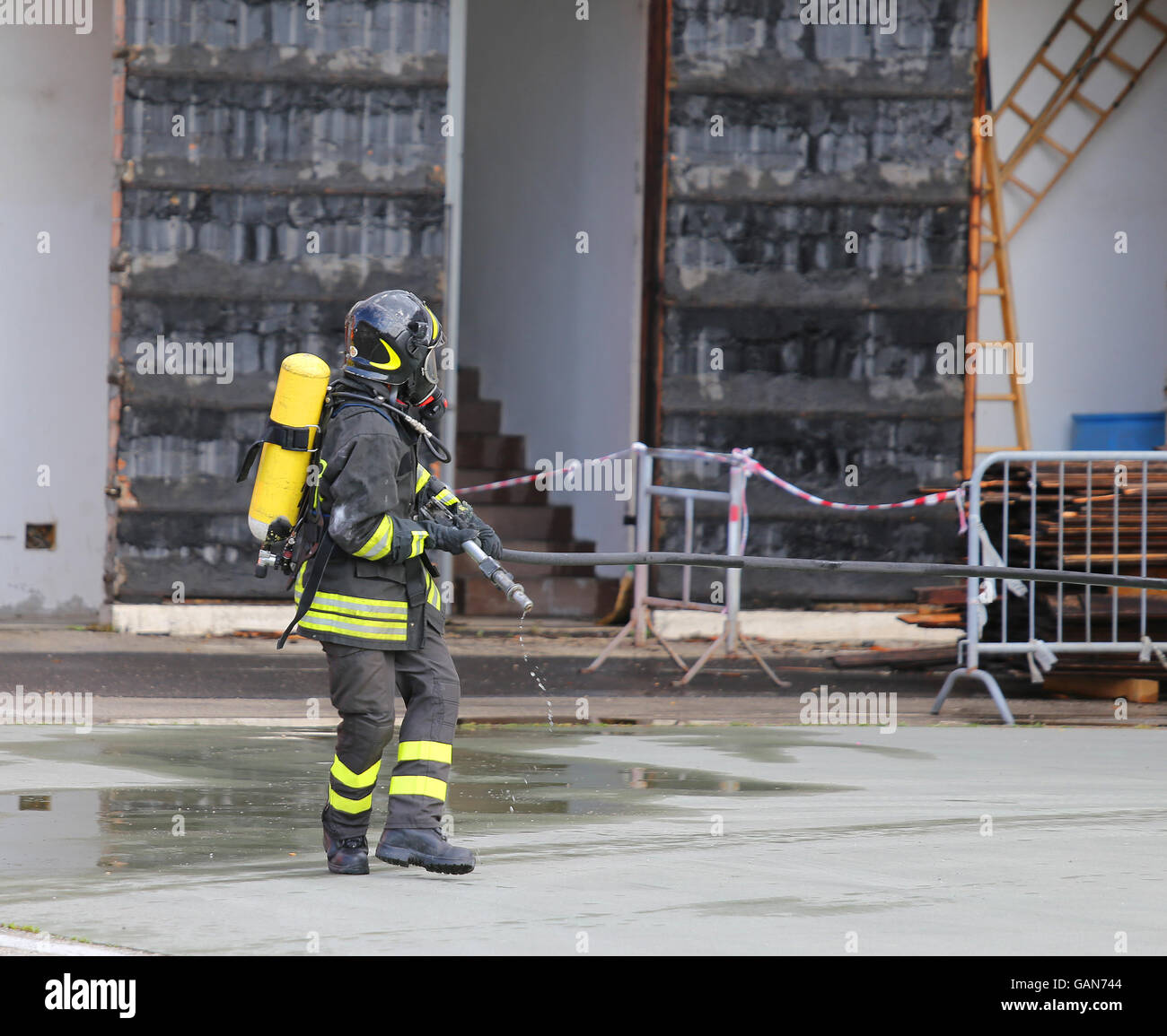 firefighters with breathing apparatus and oxygen cylinder runs with the ...