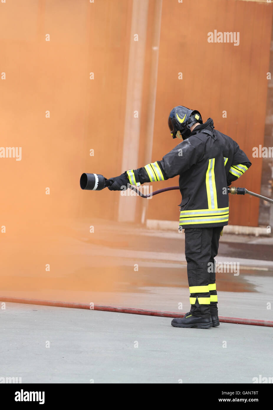 Fireman with an extinguisher during exercise in the Firehouse under the ...